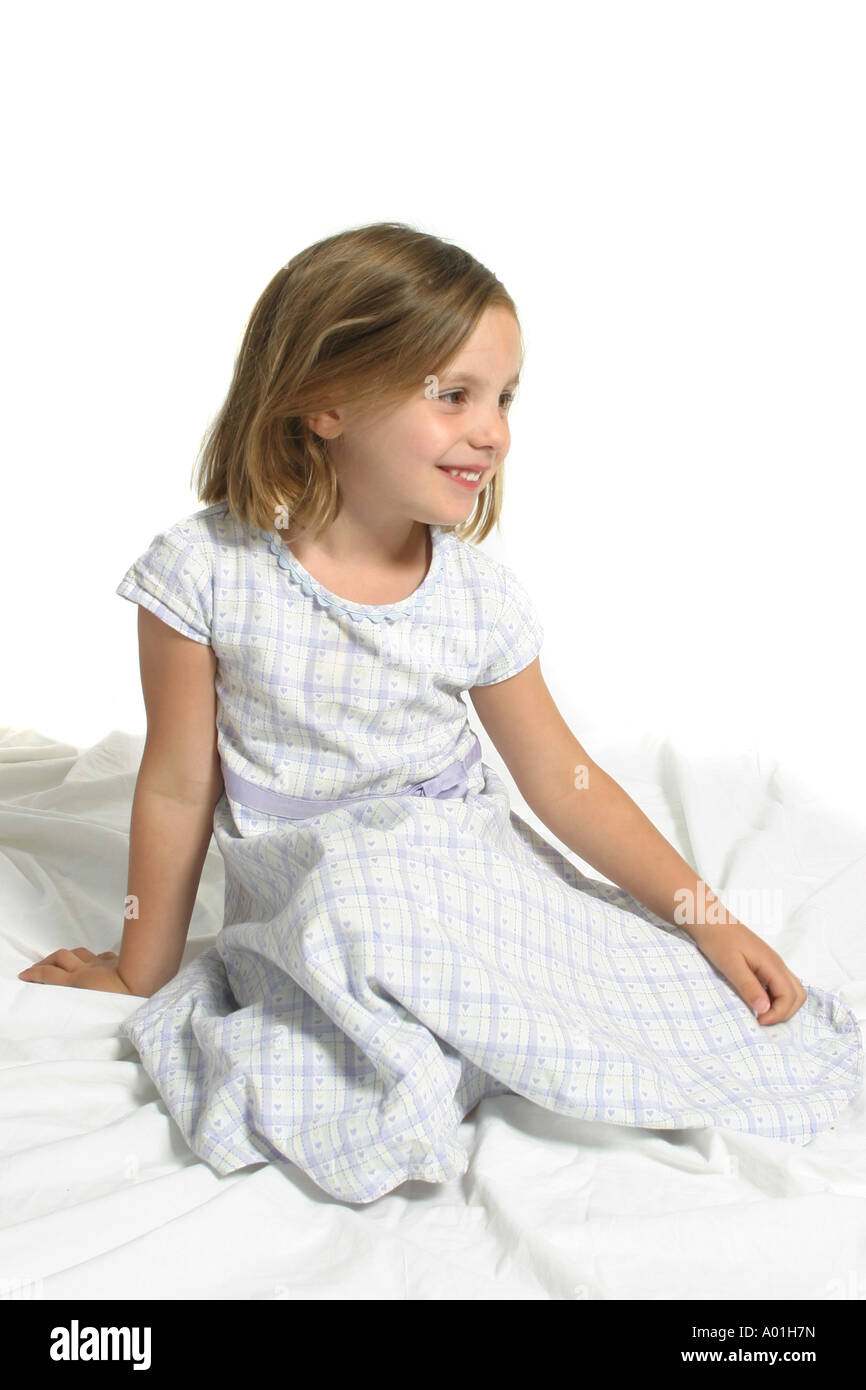 A full length portrait of a young girl sat looking away Stock Photo - Alamy