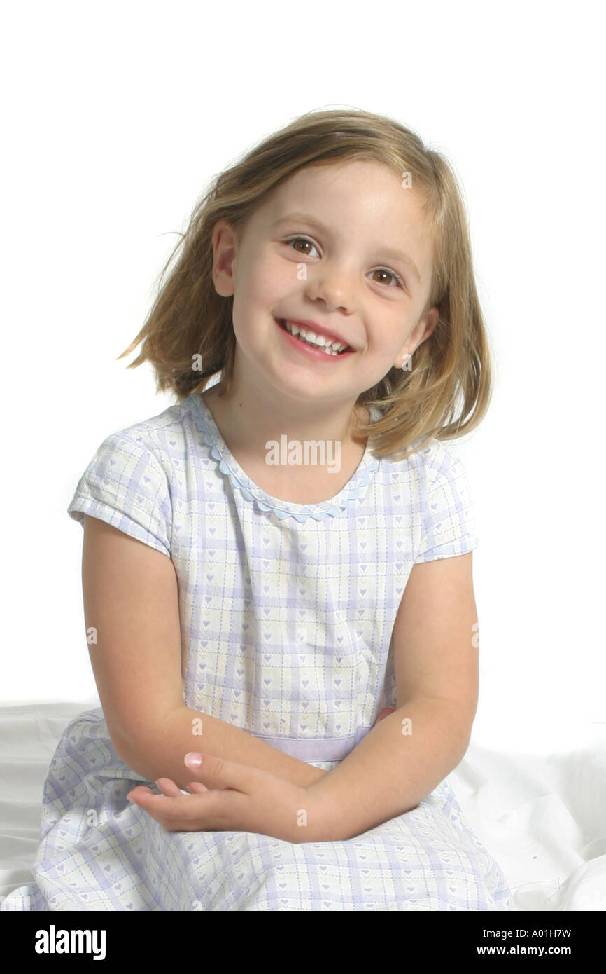 A portrait of a young girl sat looking forward very sweet and happy ...