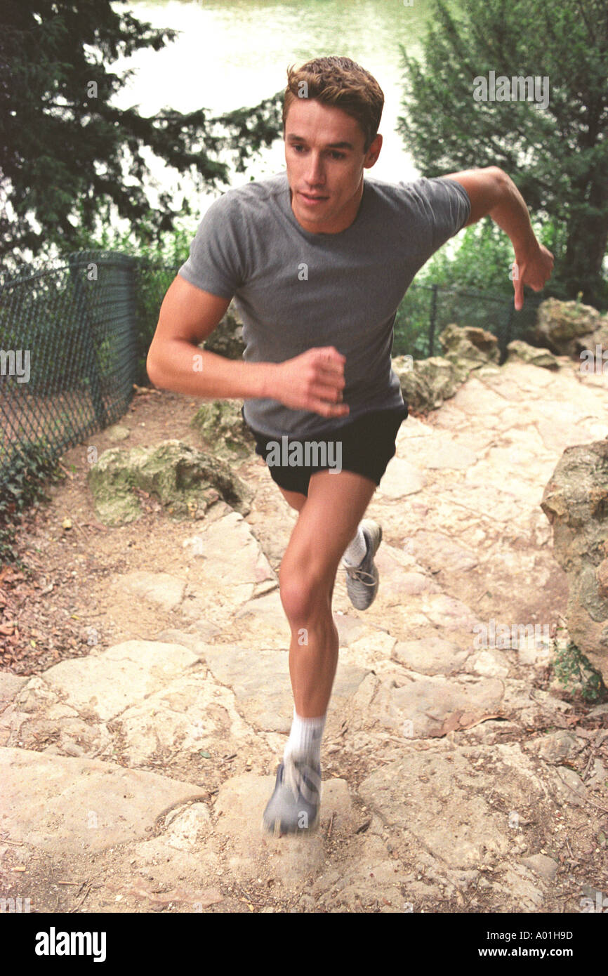 Young man running up steps Stock Photo - Alamy