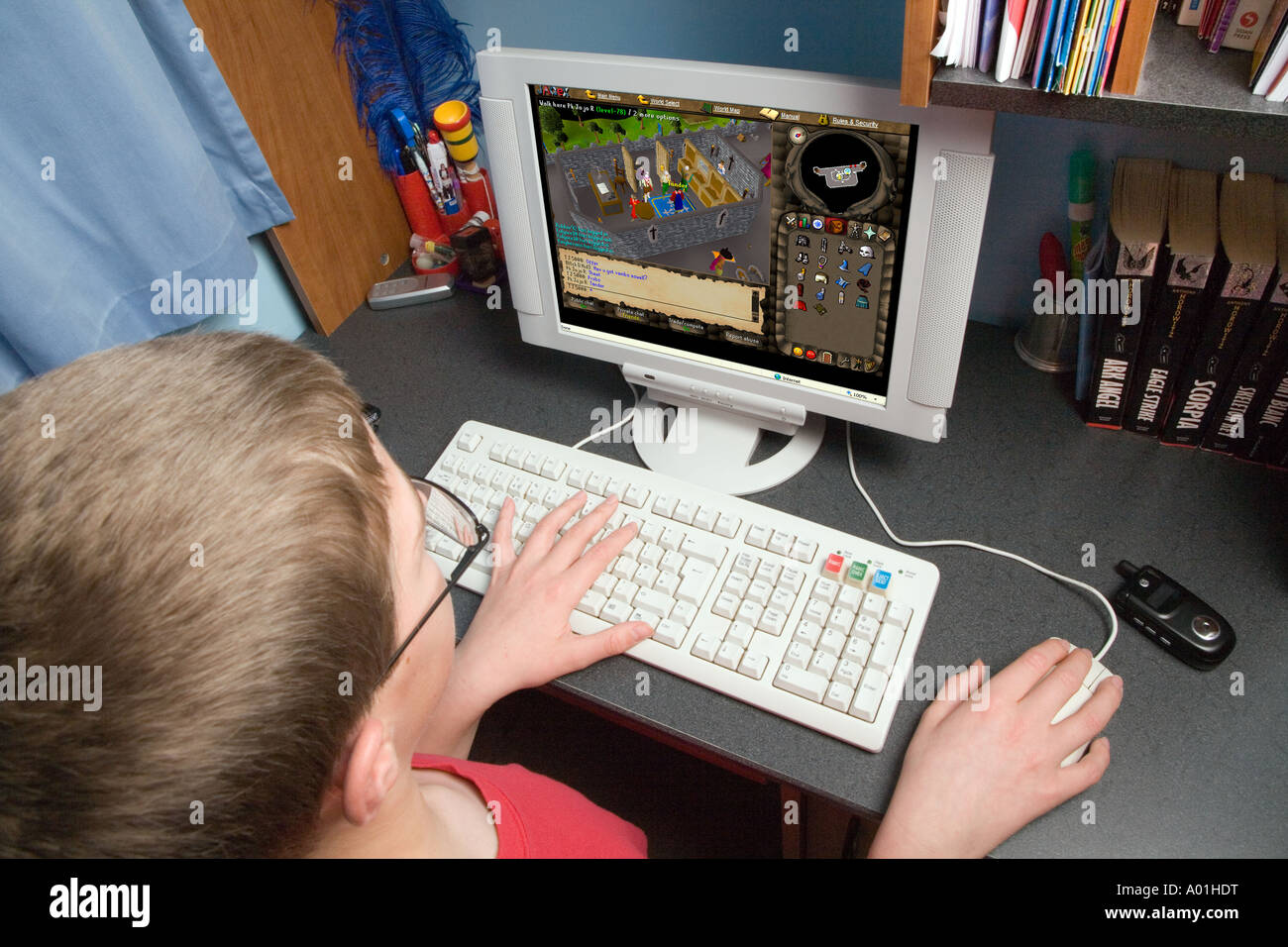 12 year old white boy playing Runescape game on PC computer at home ...