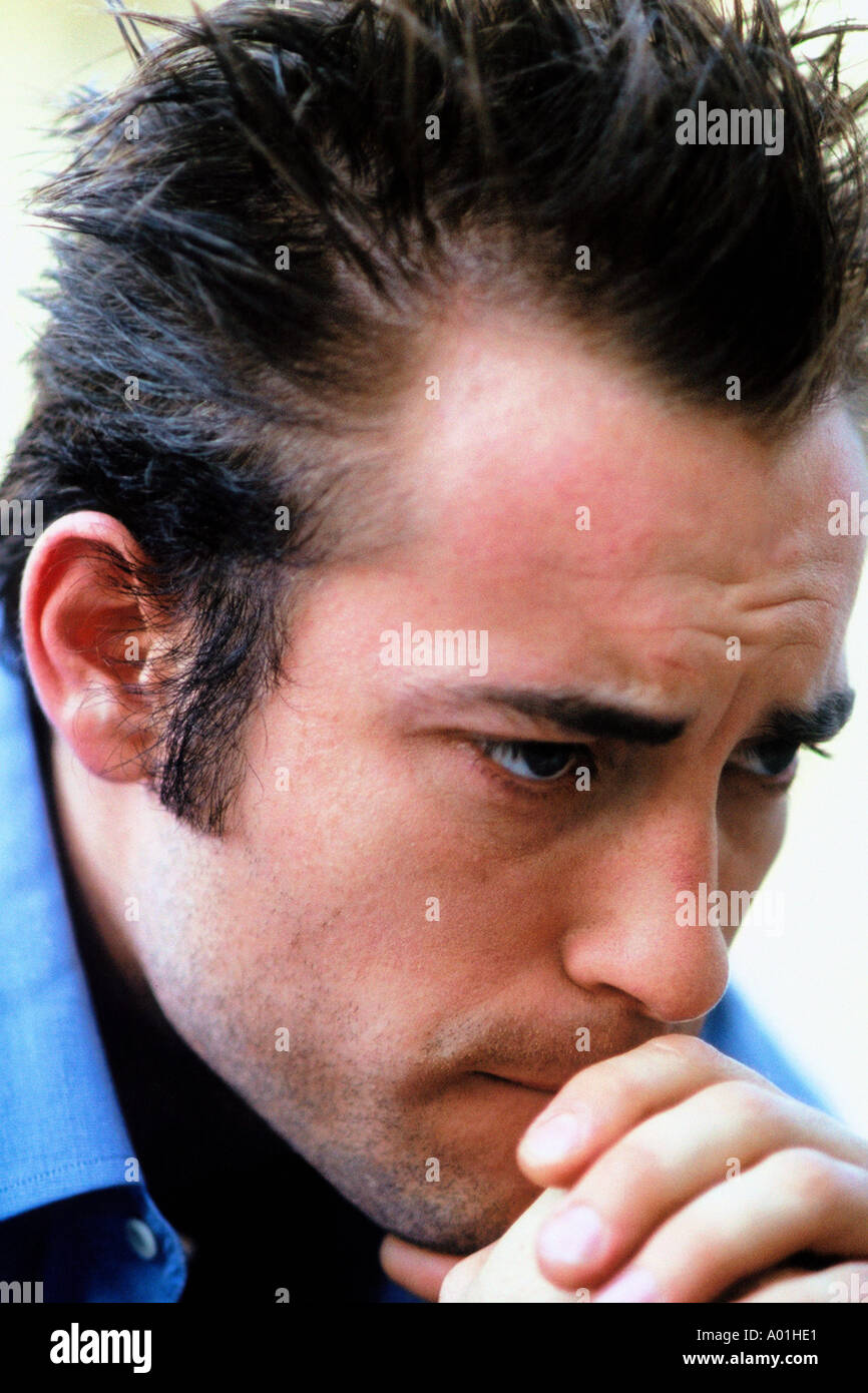 Portrait of man concentrated looking worried Stock Photo - Alamy