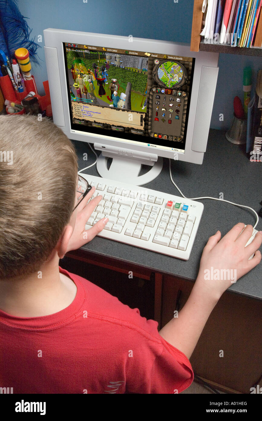 12 year old white boy playing Runescape game on PC computer at home ...