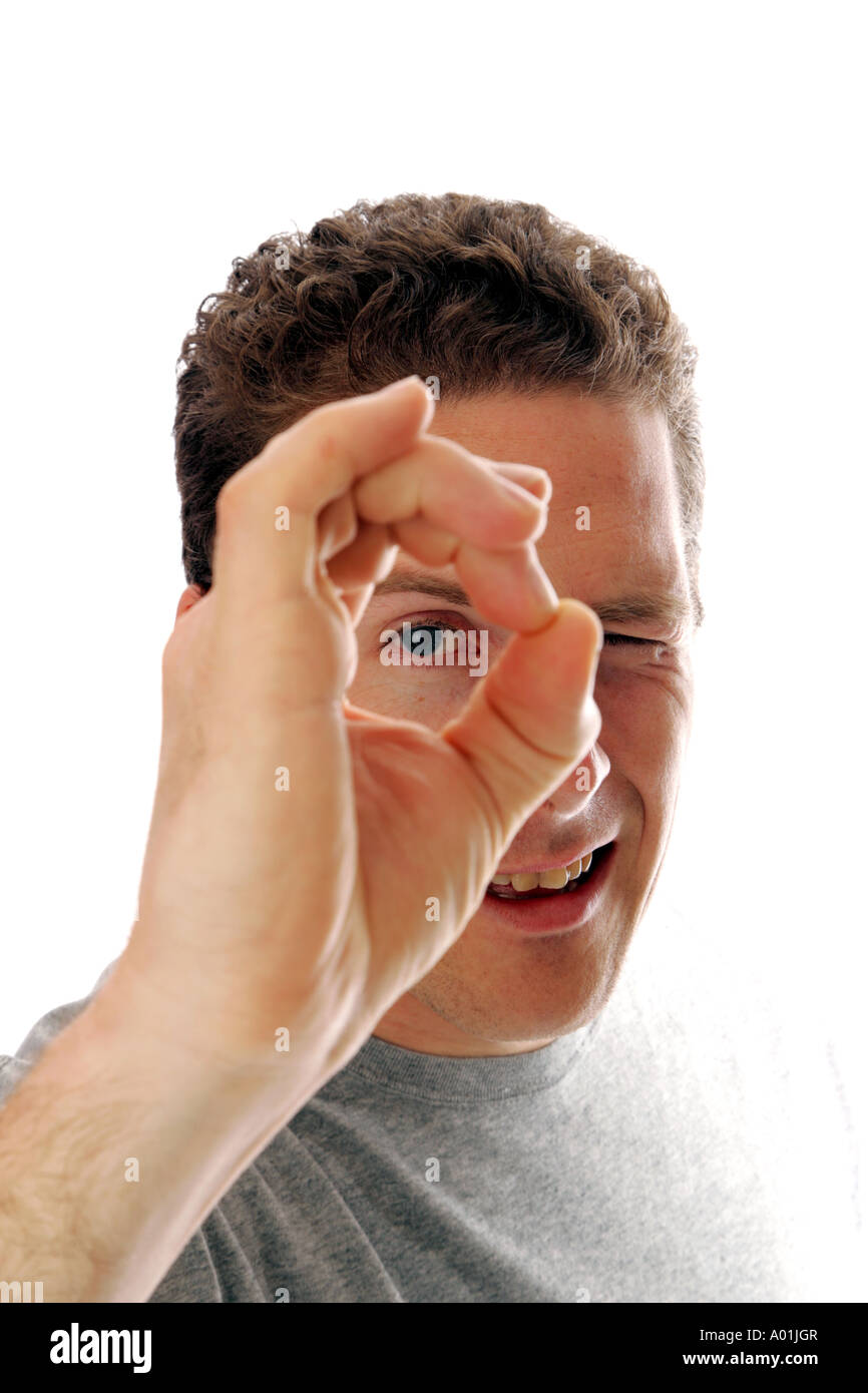 Studio shot on white background of male looking through ok symbol made ...