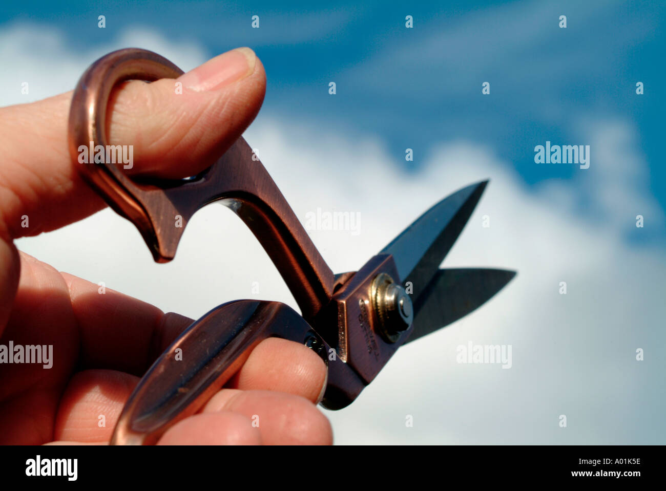 hand holding open pair of scissors Stock Photo - Alamy