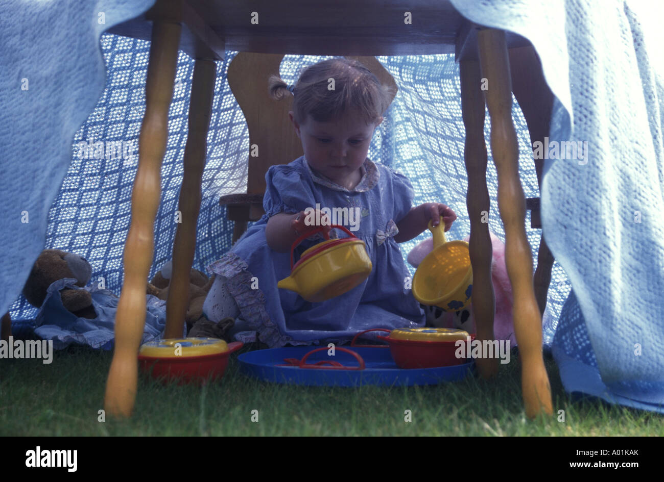child making a den with a chair and cloth Stock Photo - Alamy