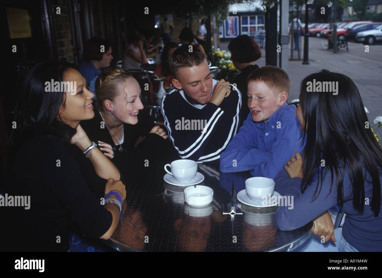 group of teenagers having coffee together in a cafe Stock Photo - Alamy