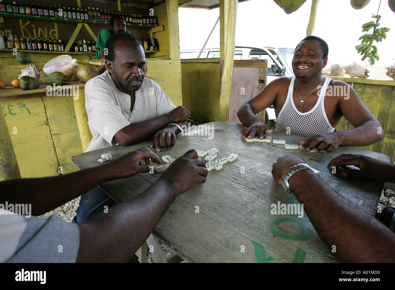 Four men play dominoes in a roadside bar, Jamaica Stock Photo - Alamy