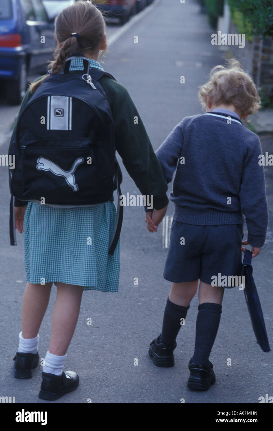 back view of children walking to school Stock Photo - Alamy