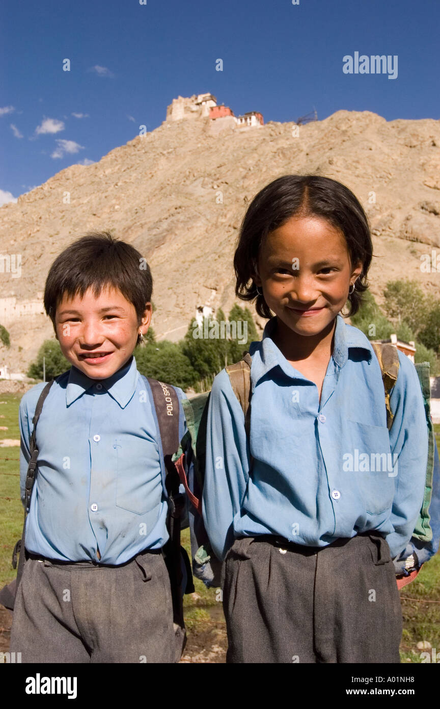 Two ladakhi school children in blue uniforms with Leh uphill monastery ...