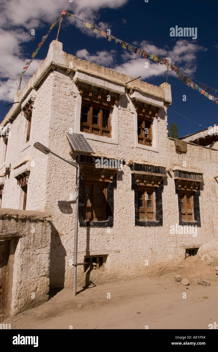 Traditional ladakhi house with Buddhist prayer flags and modern solar ...