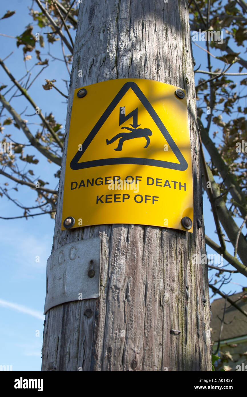 Danger of death sign screwed to a wooden telegraph pole Stock Photo - Alamy