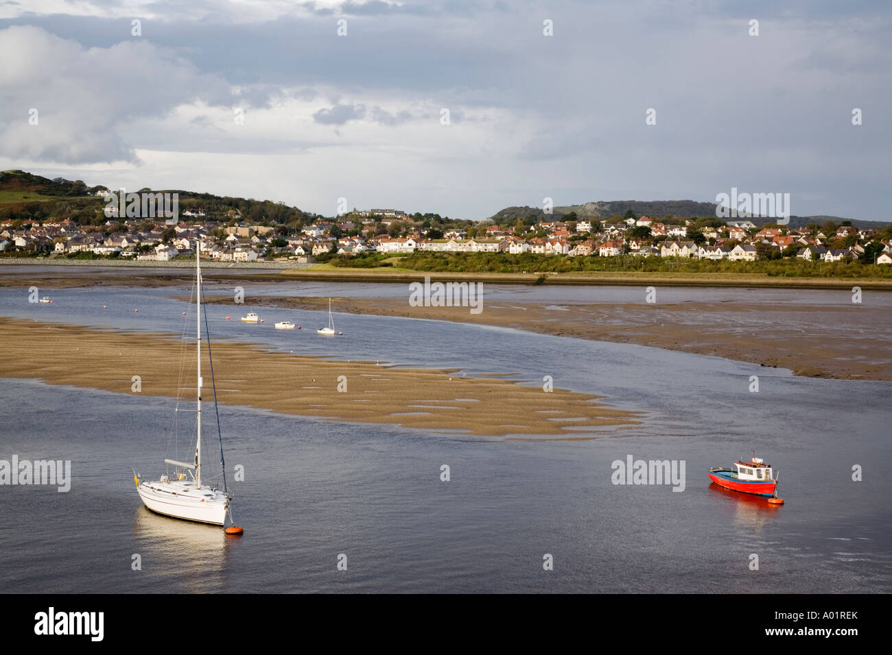 Boats on Afon Conwy River estuary harbour with sandbank at low tide ...