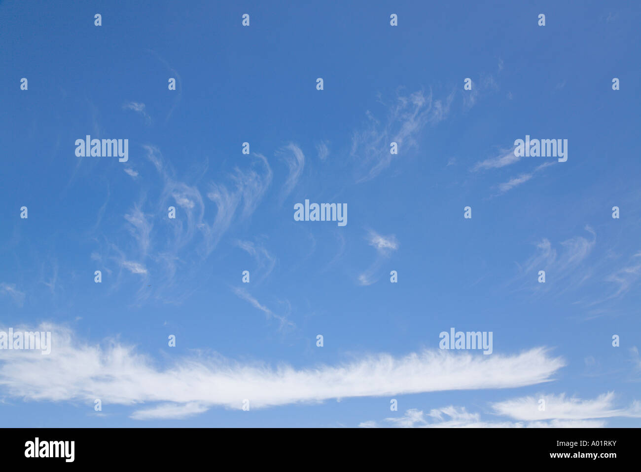Blue sky with high white Cirrus or Mares Tail clouds made of ice ...