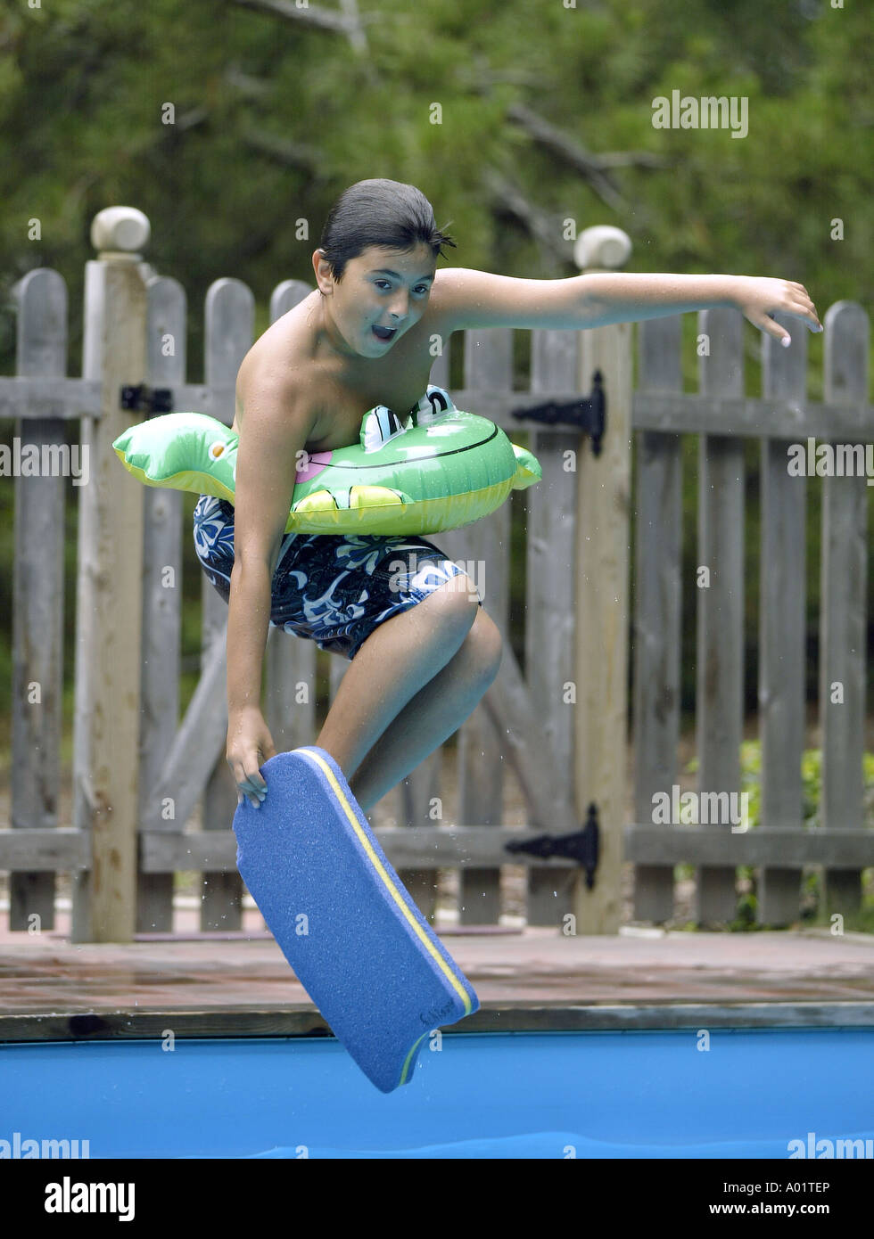 Boy jumping into a swimming pool Stock Photo - Alamy