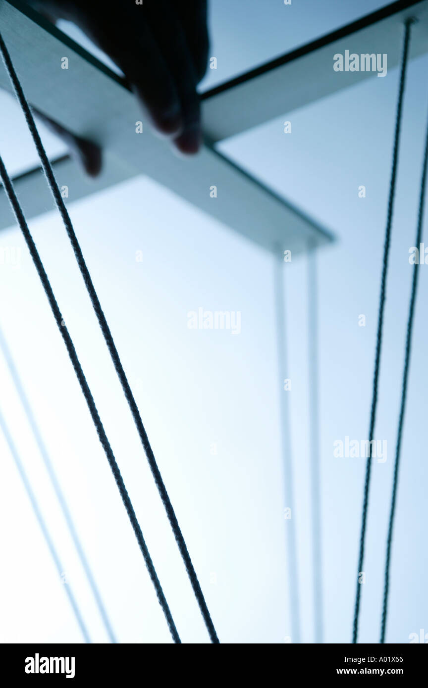 Hand on puppet strings Stock Photo - Alamy