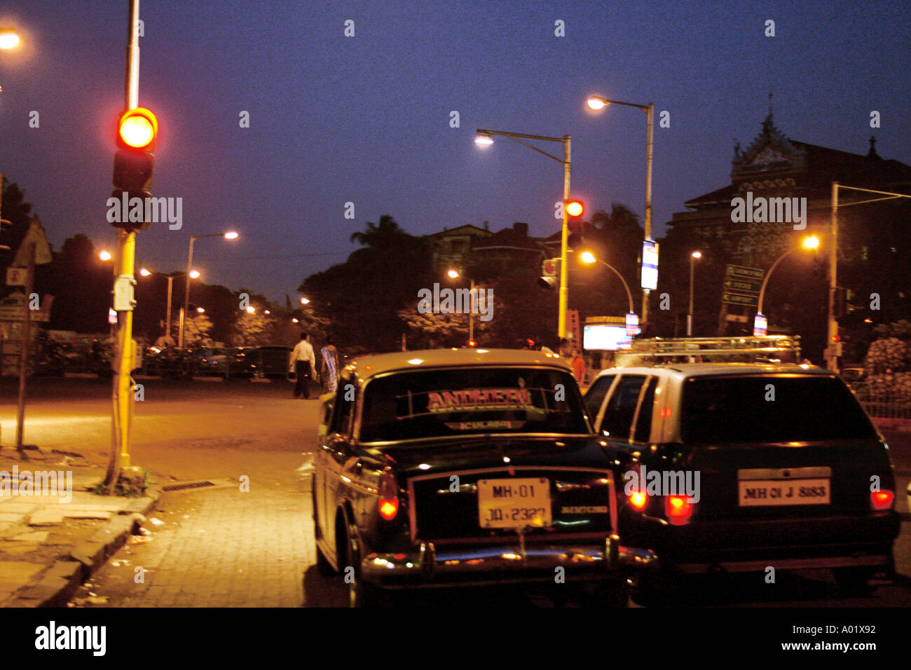 Evening street scene with two taxis Bombay India Stock Photo - Alamy