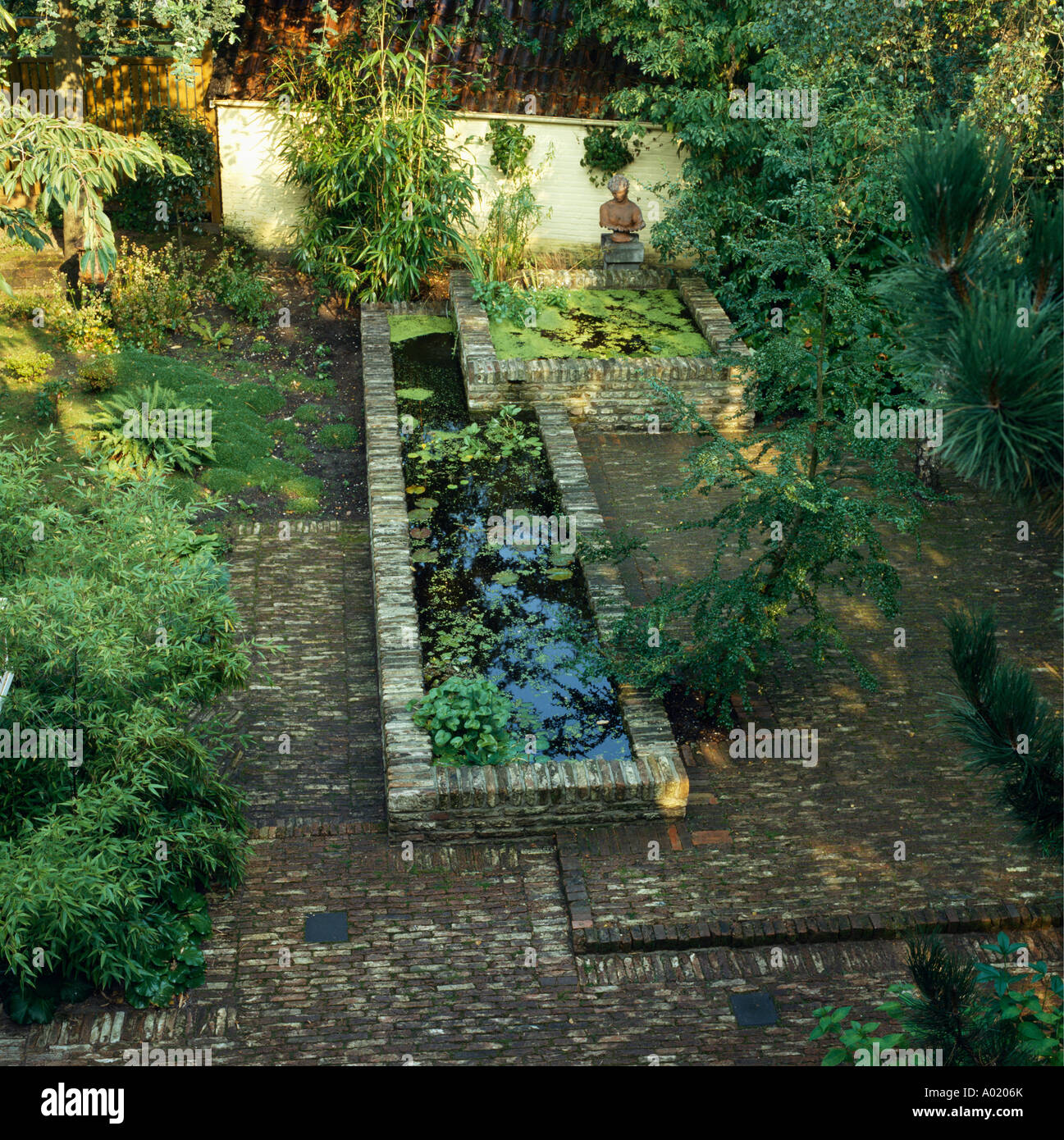 Aerial view of rectangular pond in paved courtyard with white wall ...