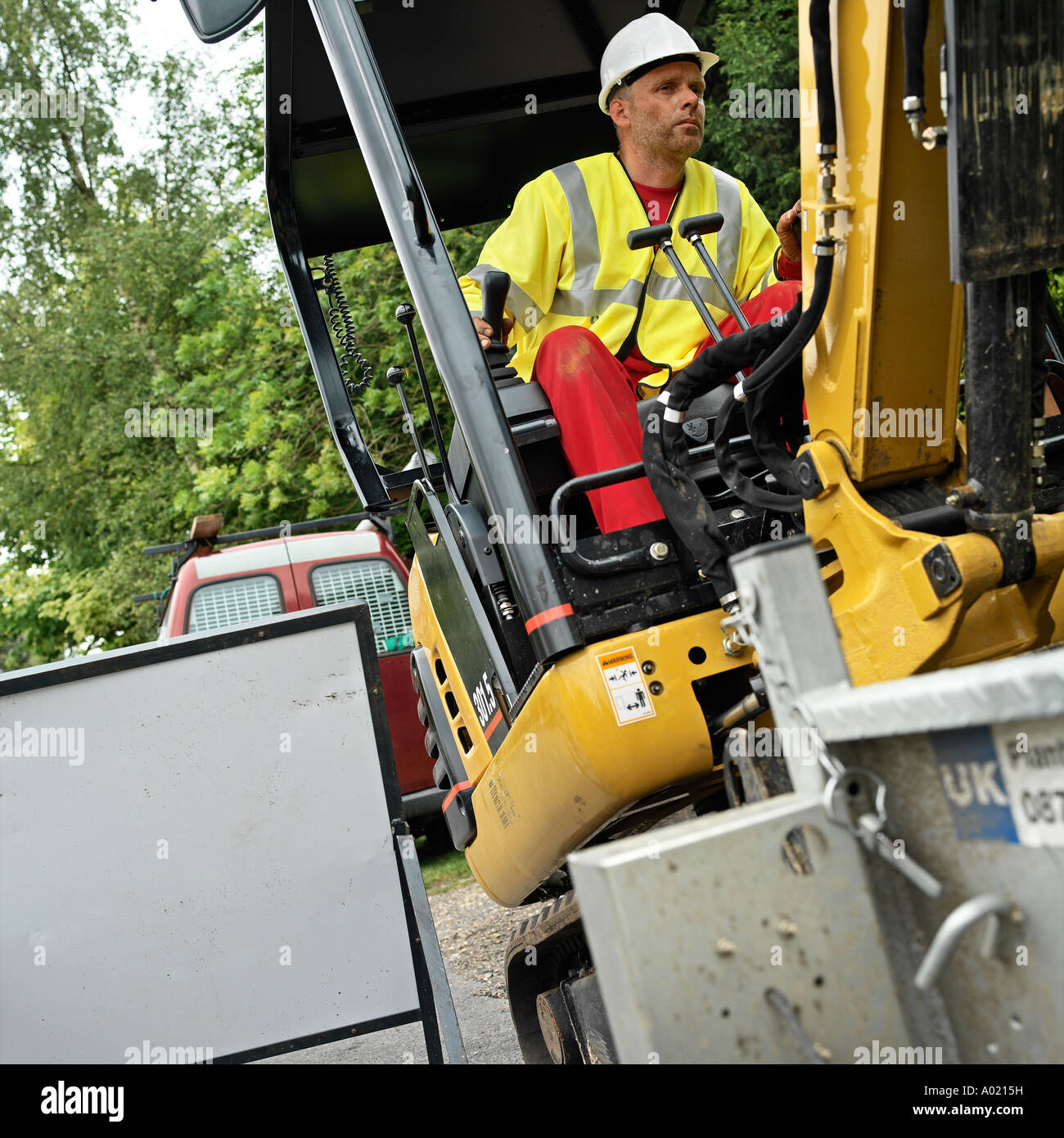 Water engineer sits in the cab of a JCB tractor Stock Photo - Alamy