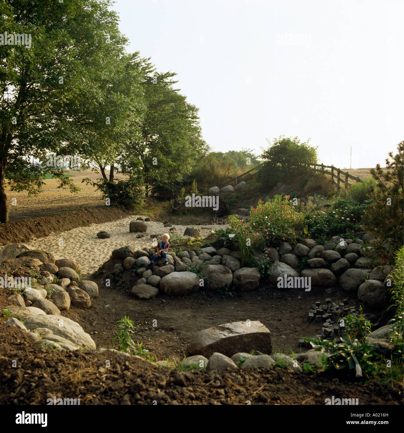 Small boy sitting on boulders hi-res stock photography and images - Alamy