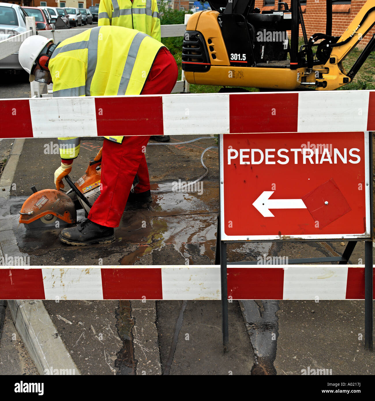 Water engineer uses a circular saw to cut through tarmac. No release ...