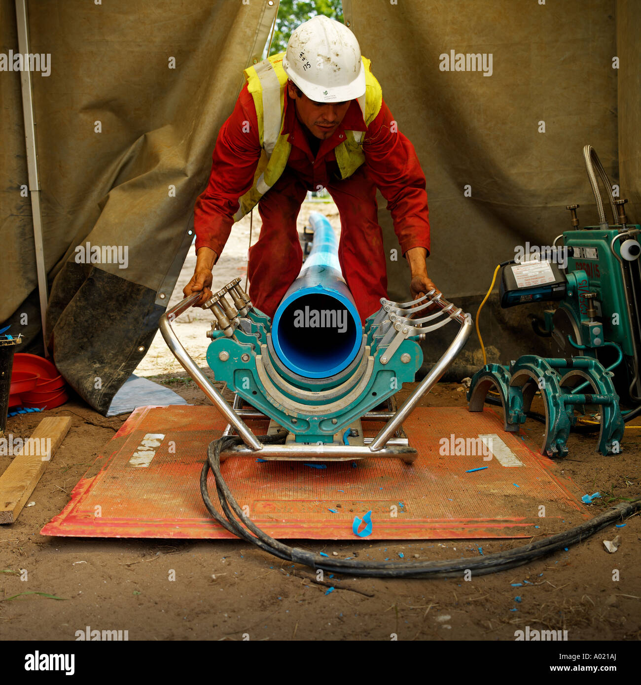 Water engineer joins plastic water pipes with a heating device Stock ...