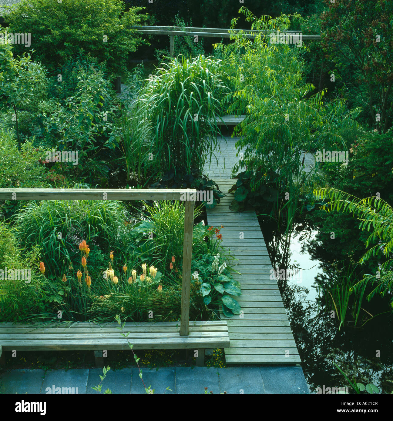 Aerial view of architectural town garden with wooden decking path ...