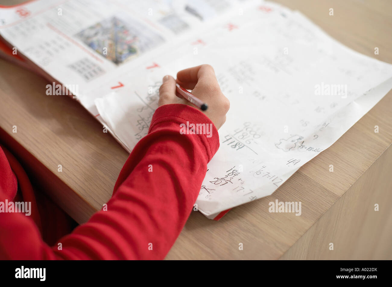 Girl doing homework on table, close up of hand on exercise book Stock ...