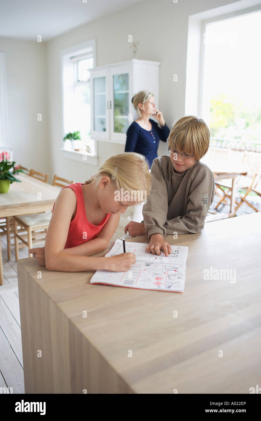 Mother children doing homework kitchen hi-res stock photography and ...