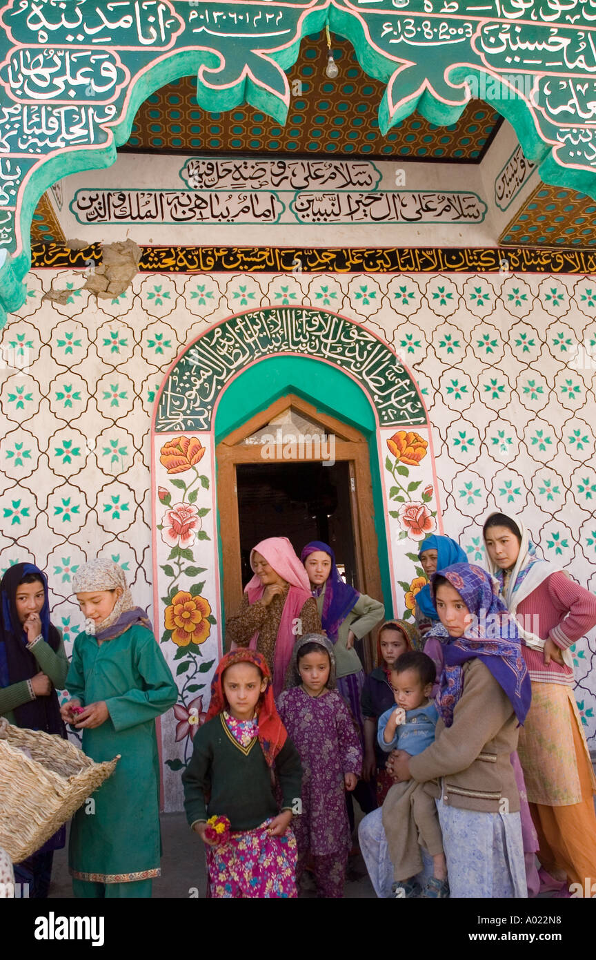 A group of Muslim Dard or Brokpa woman outside mosque looking at camera ...