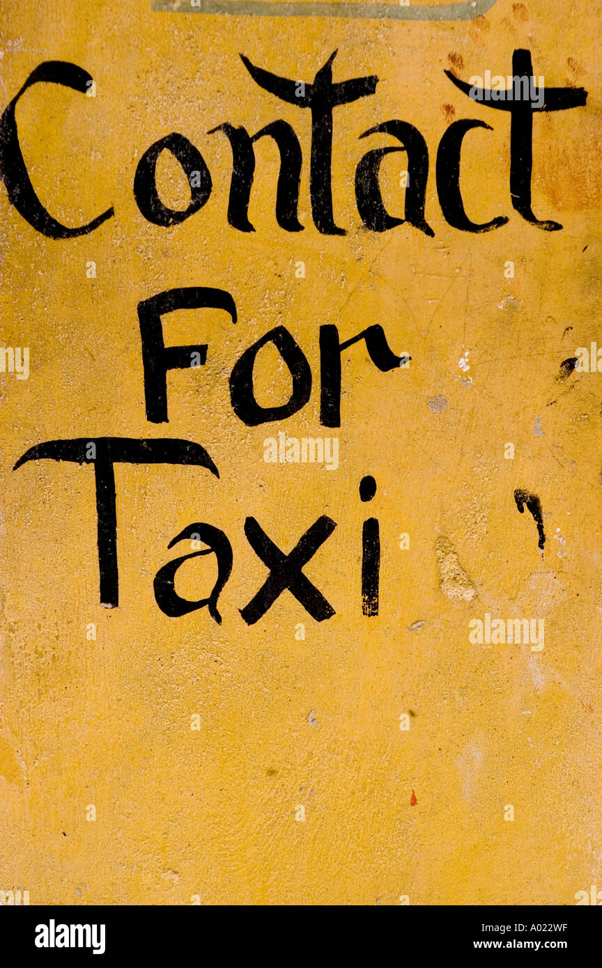 Contac for TAXI mural black sign on yellow background India Stock Photo ...