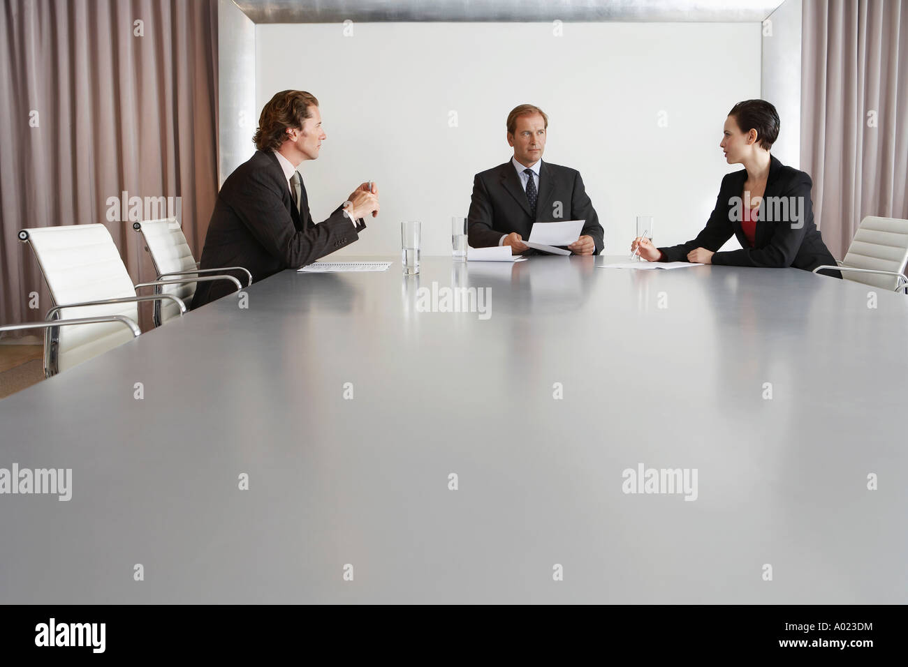 Three Businesspeople Meeting in Conference Room Stock Photo - Alamy