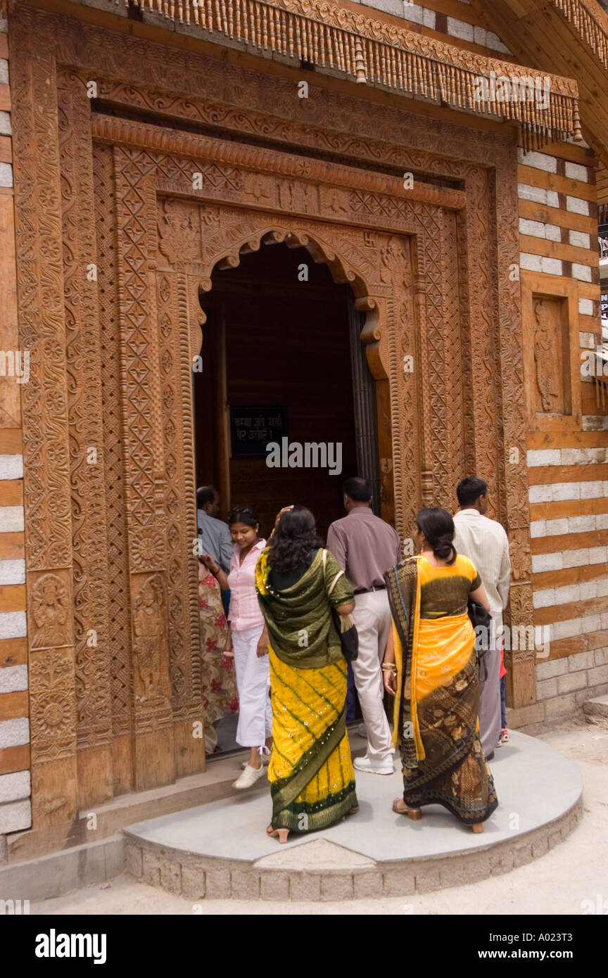 Traditional dress Indian people entering wood carved hot springs in ...