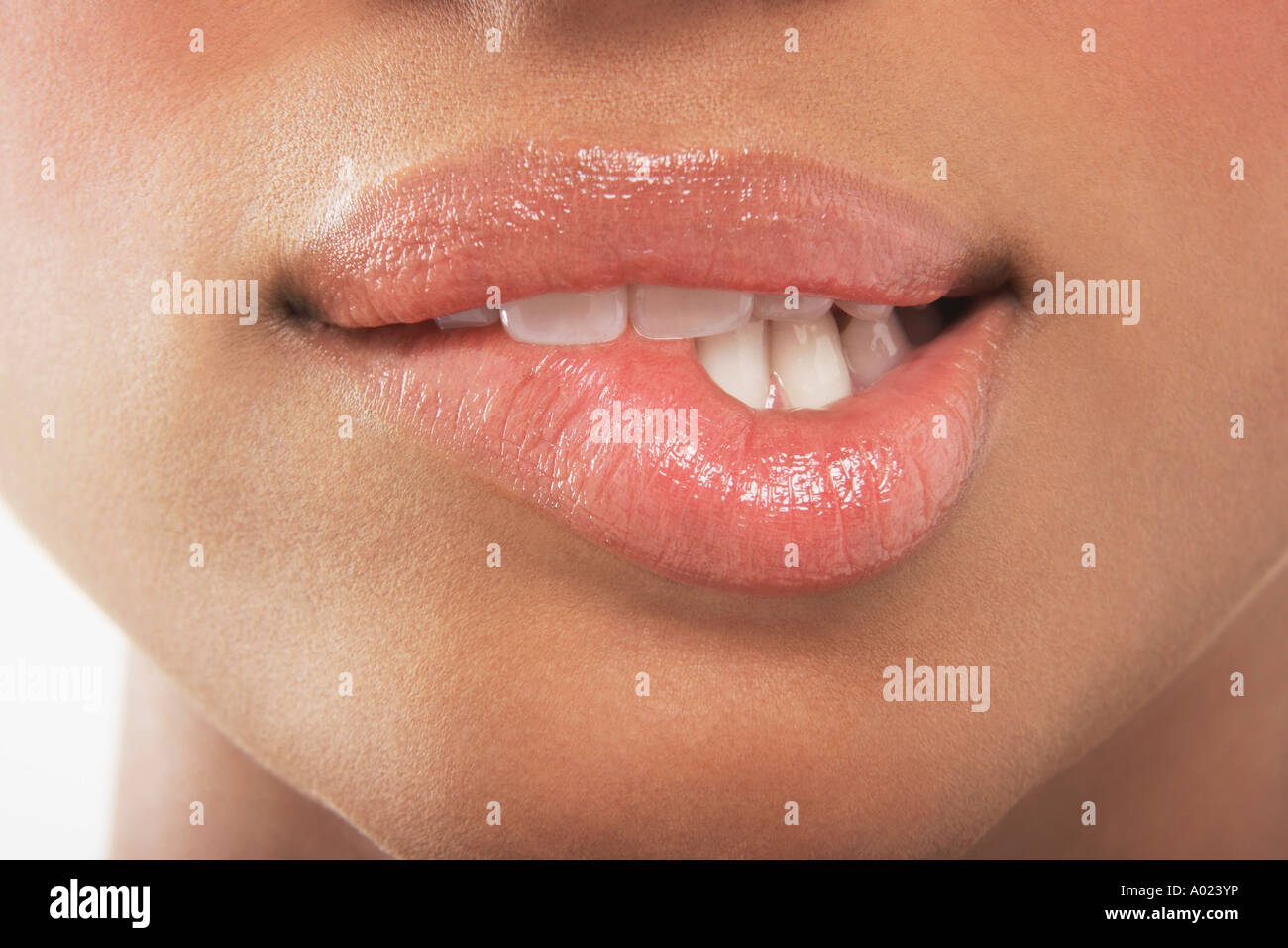 Woman biting lip Stock Photo - Alamy