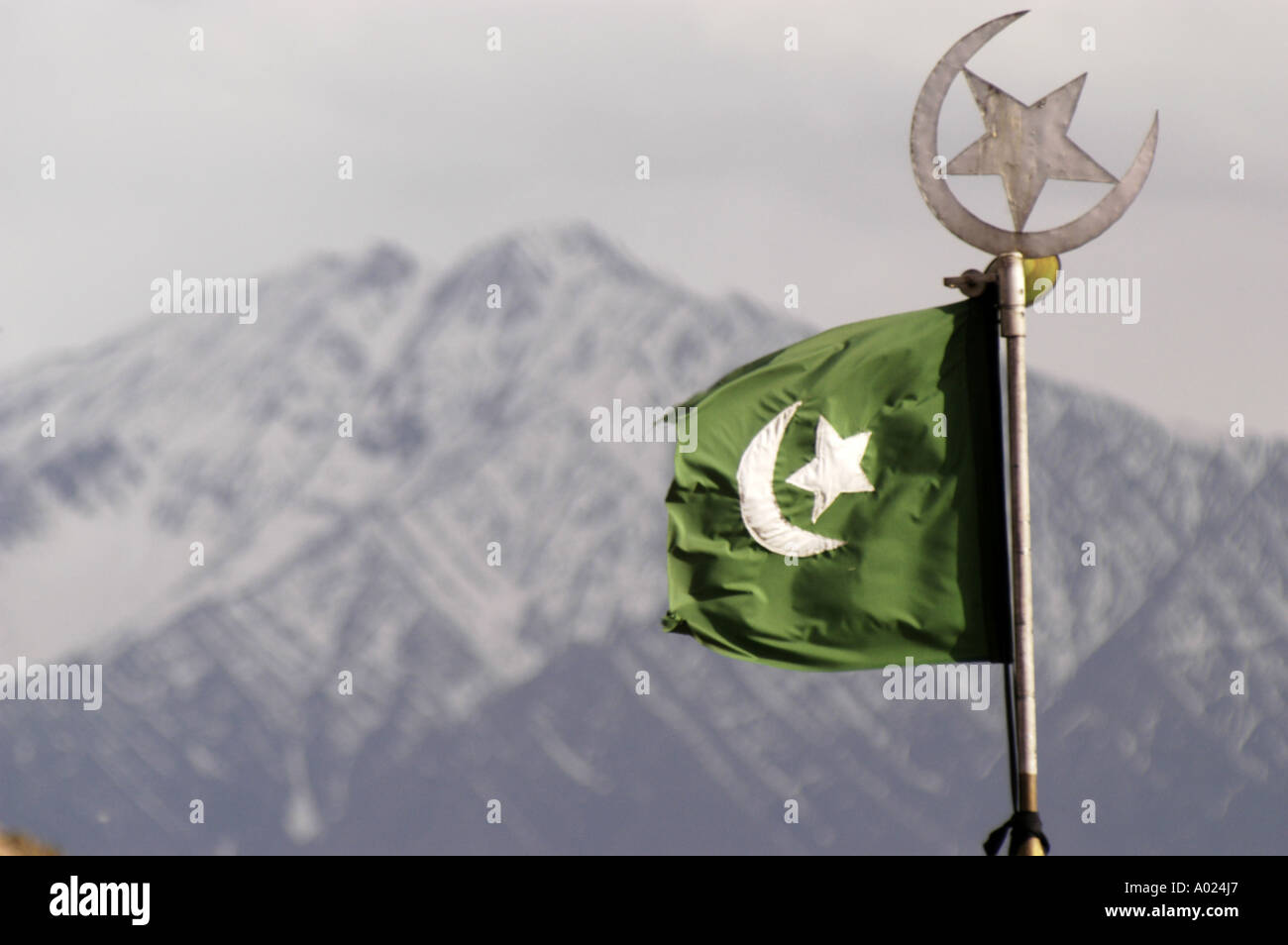 Muslim star and moon on flag top of Jama Masjid mosque with snow capped ...