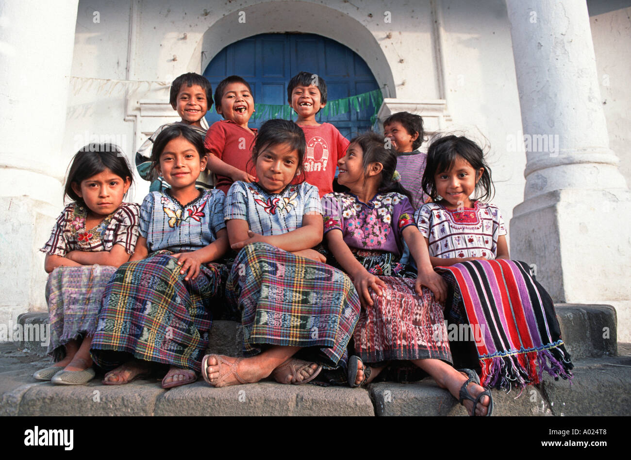 A group Maya girls and boys from Santiago Atitlan seated at the top of ...