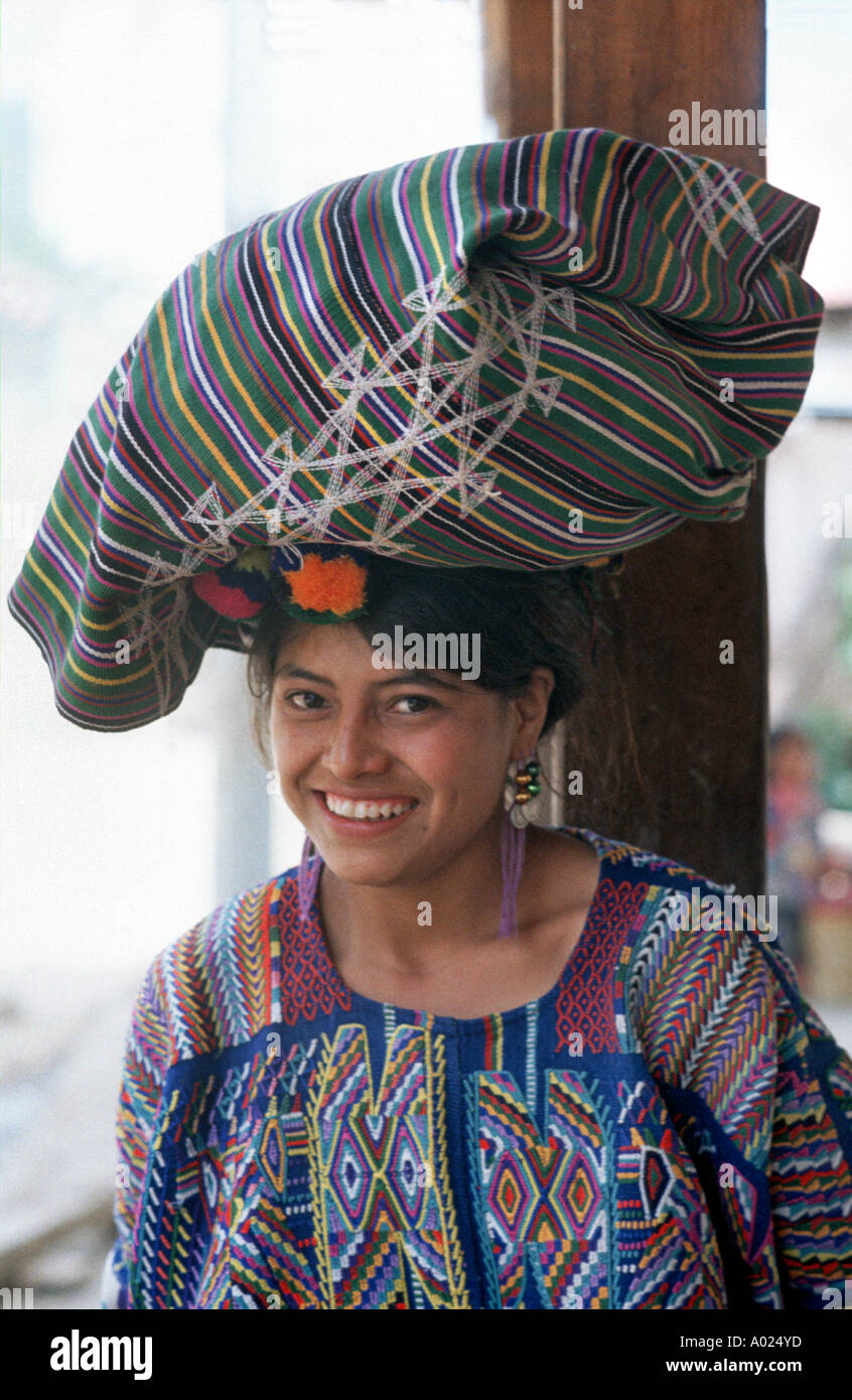 Ixil Maya girl balancing a large bundle on her head and wearing the ...