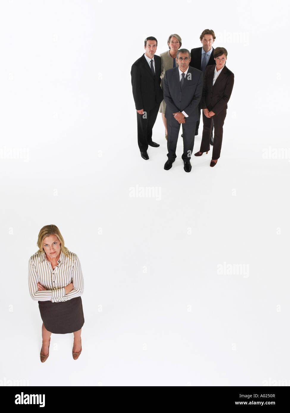 Businesswoman standing apart from group Stock Photo - Alamy