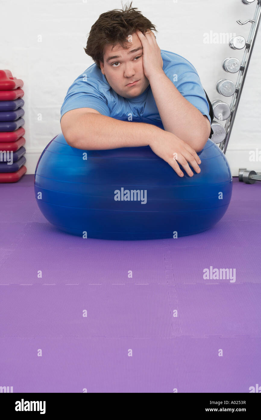 Overweight Man Resting on Exercise Ball Stock Photo - Alamy