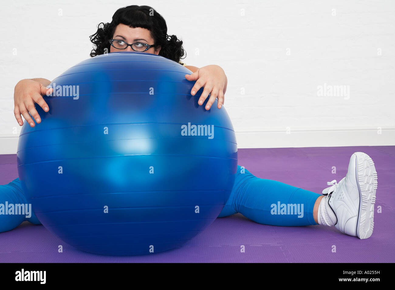 Uninspired overweight Woman sitting Behind Exercise Ball Stock Photo ...