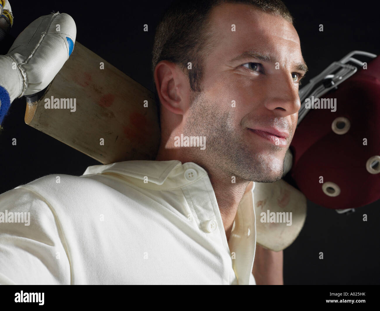 Cricket player holding cricket bat behind shoulders, close-up Stock ...