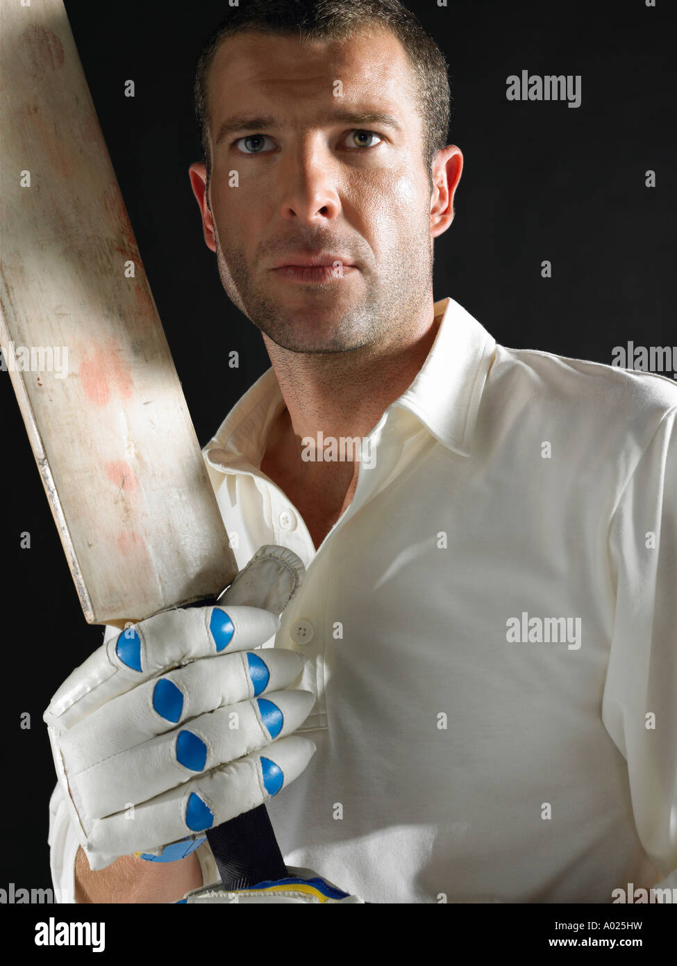 Cricket player holding cricket bat, portrait Stock Photo - Alamy