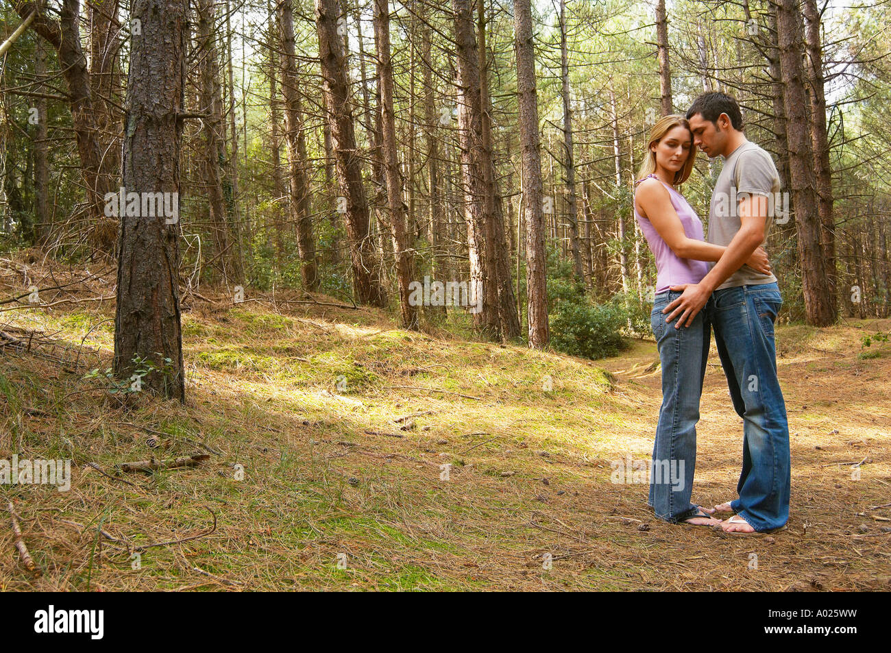 Couple standing on forest trail Hugging, side view Stock Photo - Alamy