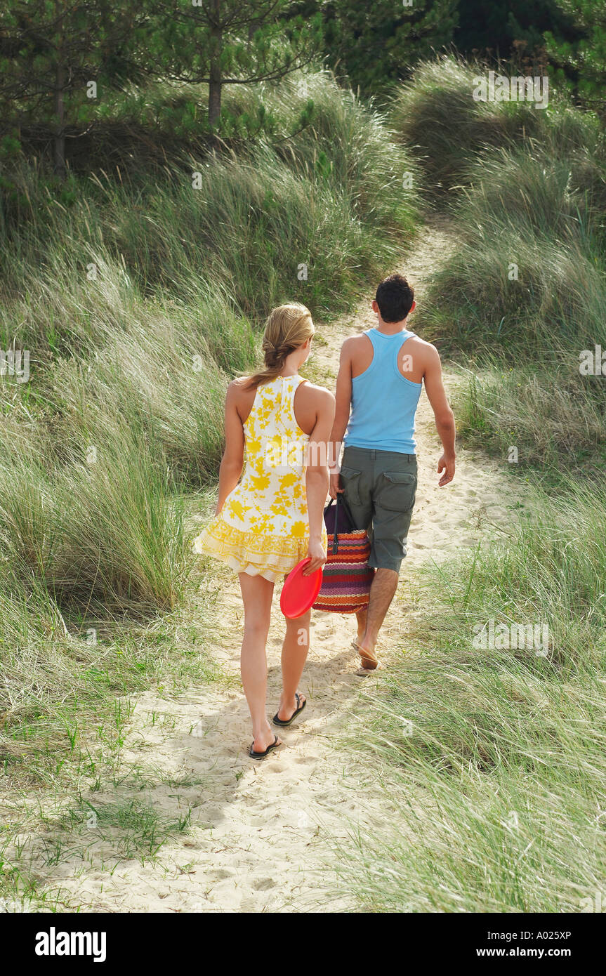 Woman leaving beach carrying hi-res stock photography and images - Alamy