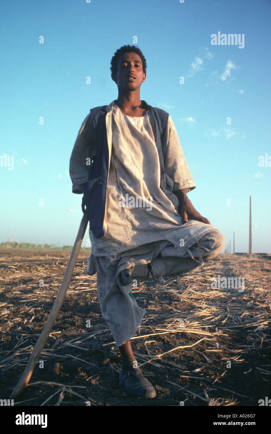 Sudan Classical one legged resting pose with a stick and one leg stuck ...