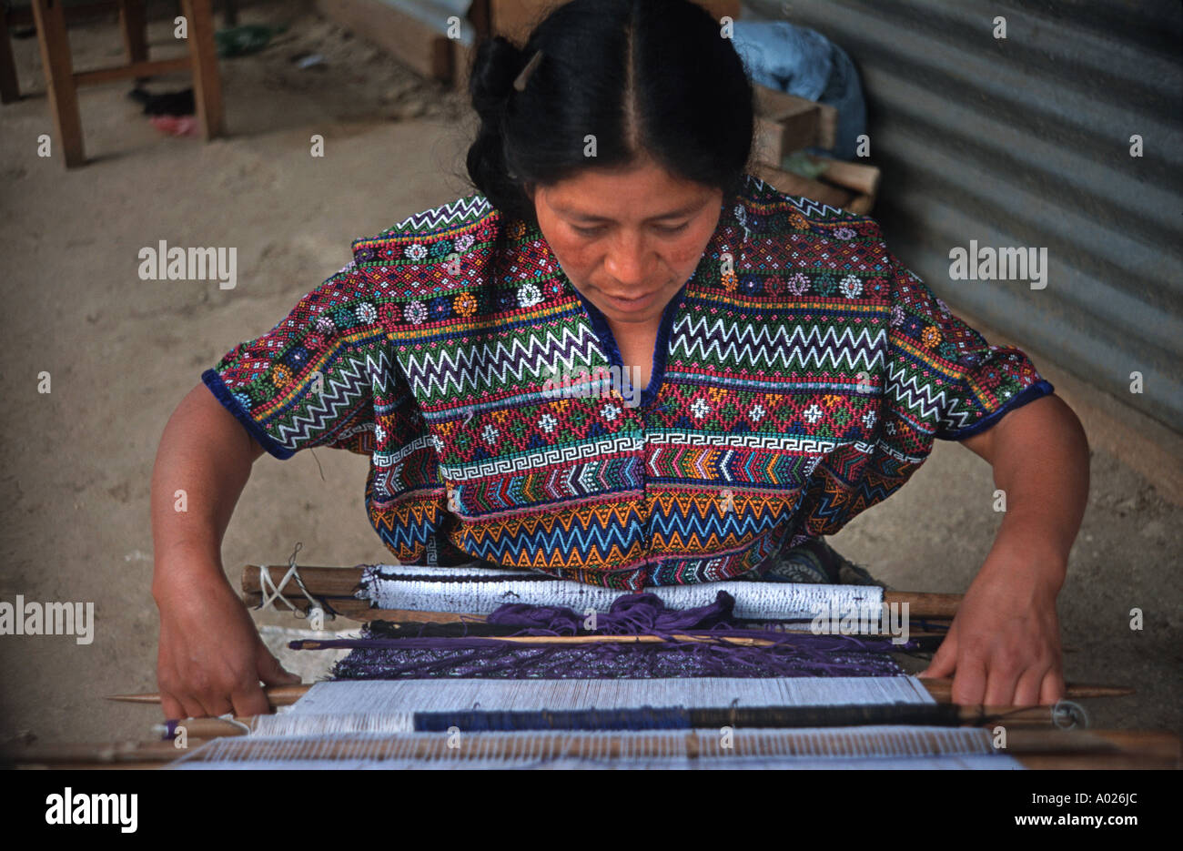 Maya woman from San Martin Jilotepeque working on a hipstrap loom and ...