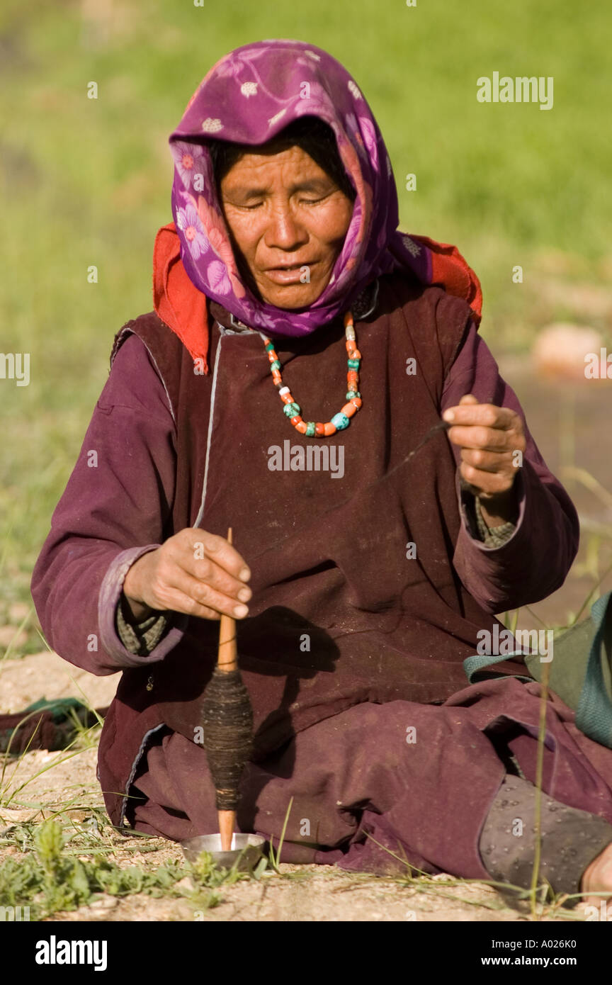 Old Ladakhi woman in traditional dress and jewellery weaving on the ...