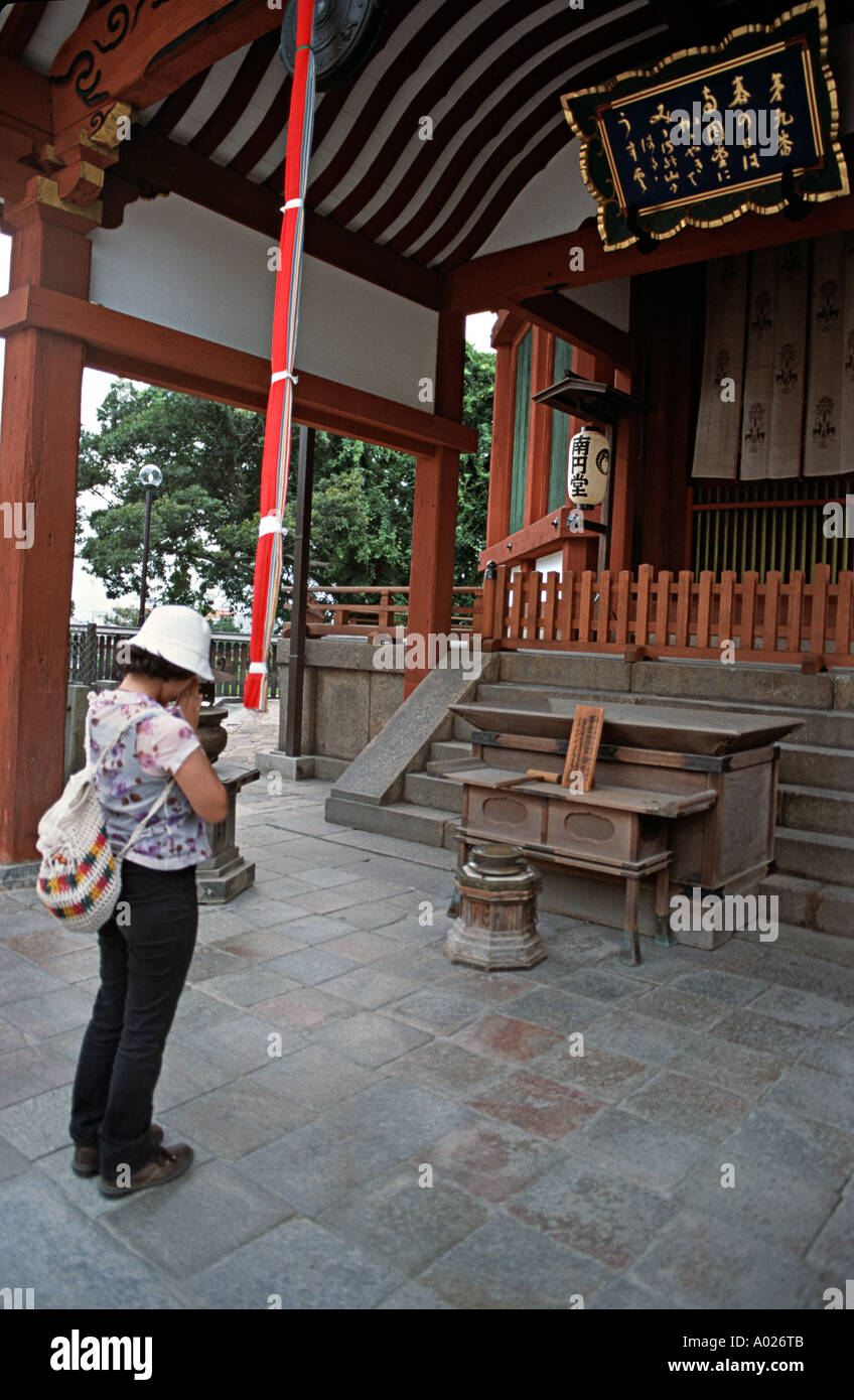 Young Japanese women in prayer at a Japanese temple Nara prefectue ...