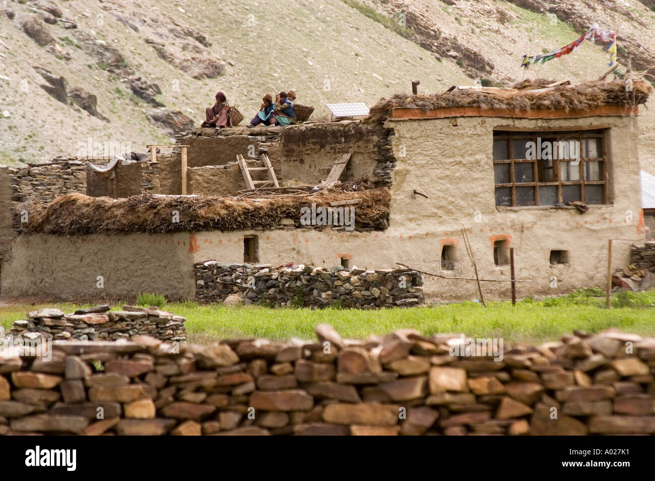People sitting on the roof of traditional Zanskari house in Rangdum ...