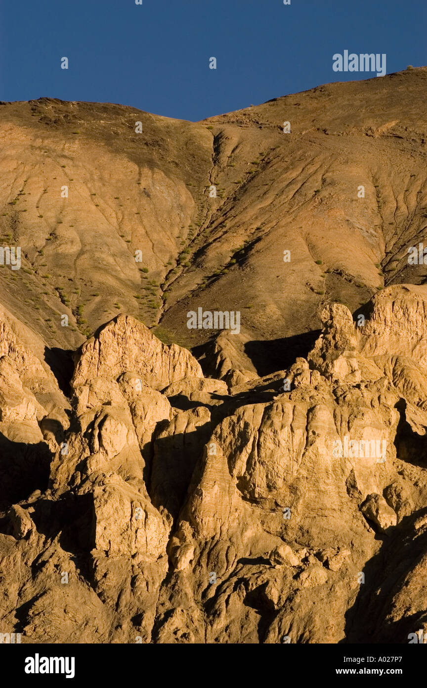 Yellow strange scenic rock formations of empty sediment lake with blue ...