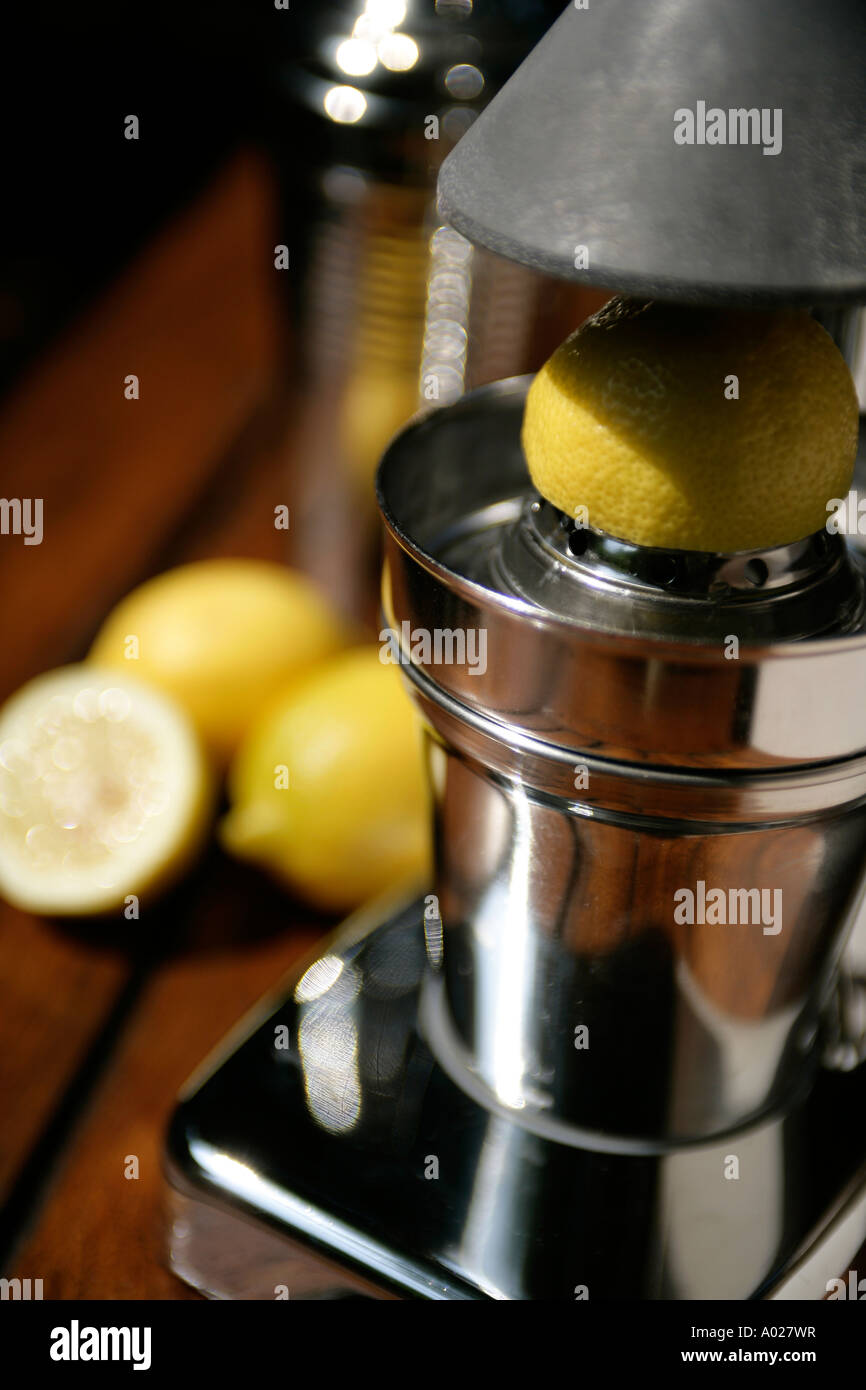 Lemons being juiced Stock Photo - Alamy